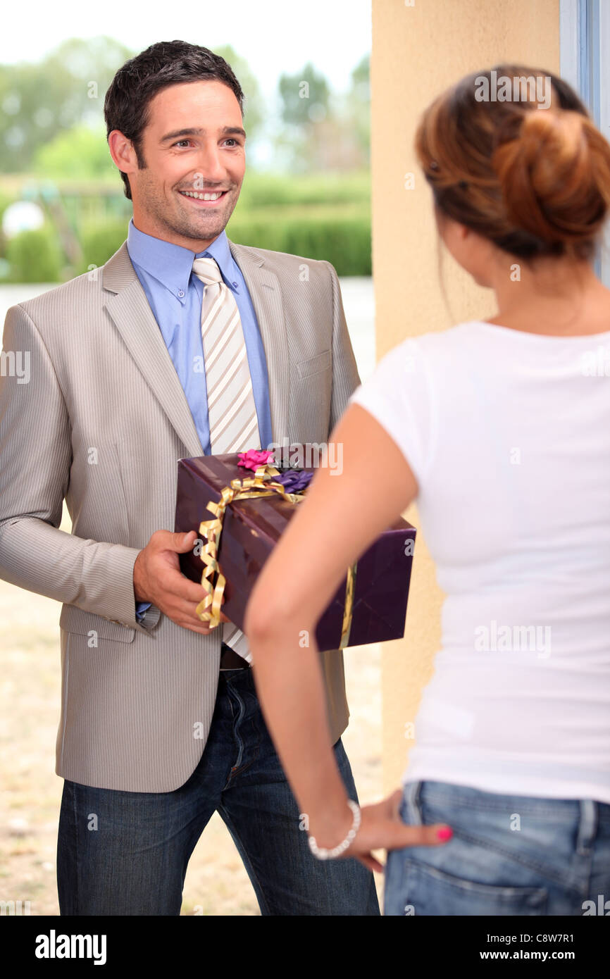 Man giving gift to woman Stock Photo - Alamy