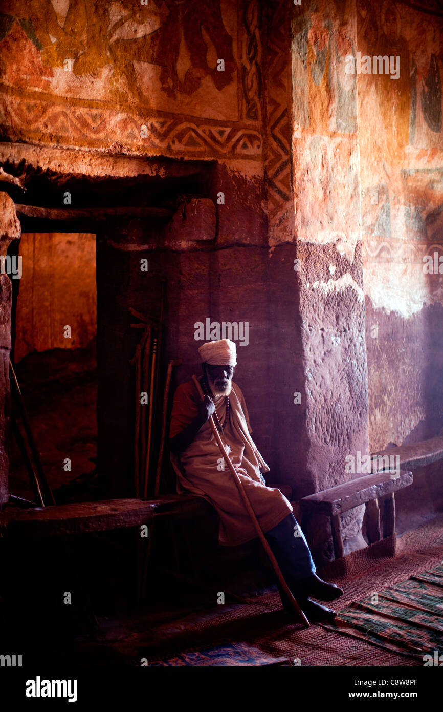 The elderly caretaker resting inside the rock-hewn church of Debre ...