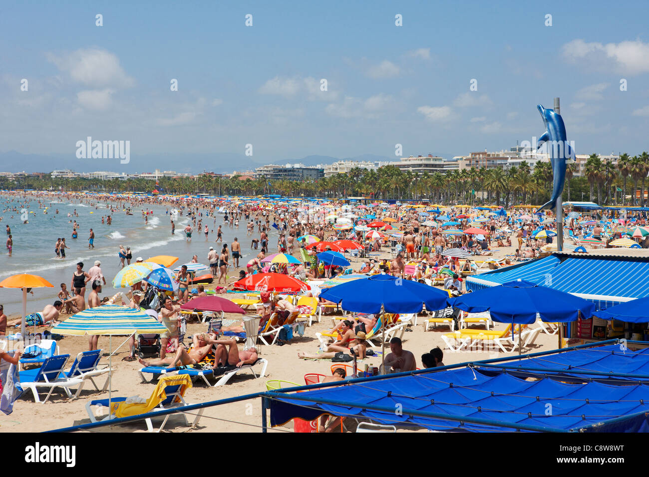 Elevated view of overcrowded Els Pilons Beach in Salou, Catalonia ...