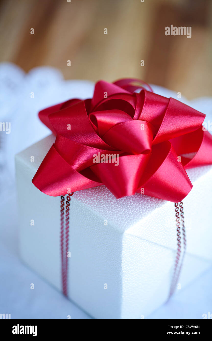Gift wrapped by red ribbon hi-res stock photography and images - Alamy