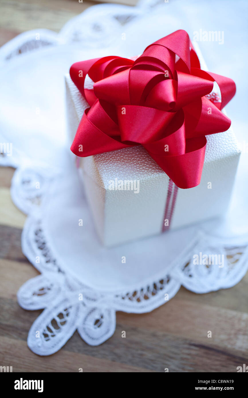 Wrapped Christmas Gift Box With Red Ribbon Stock Photo - Alamy