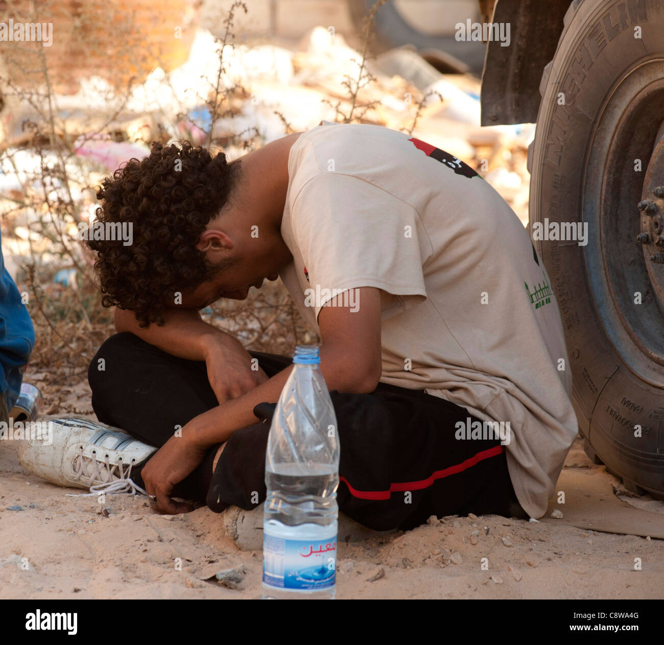 Exhausted rebel fighter on the road from Zarwiya to Tripoli Stock Photo ...