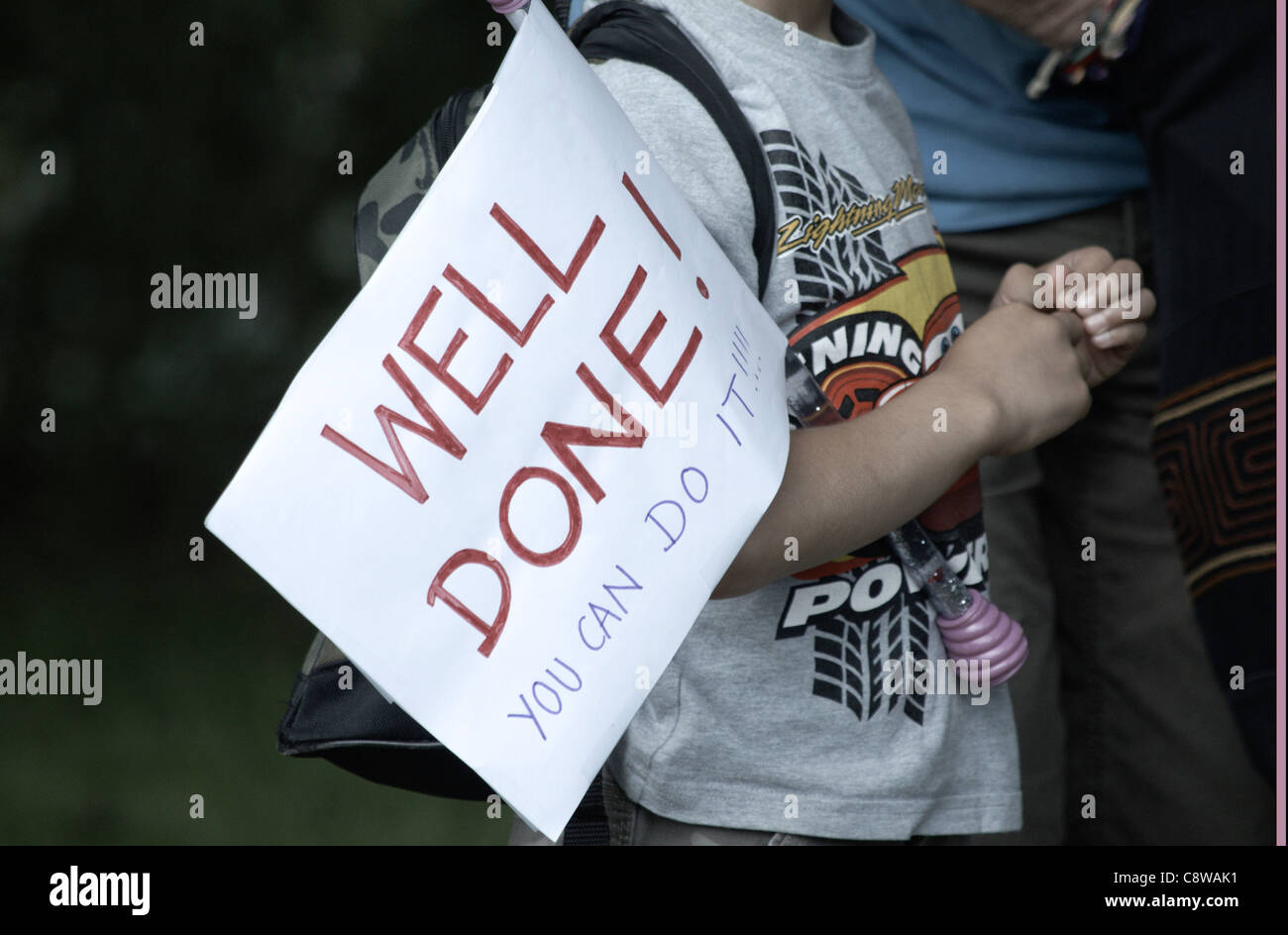 Boy with a sign saying "WELL DONE Stock Photo - Alamy