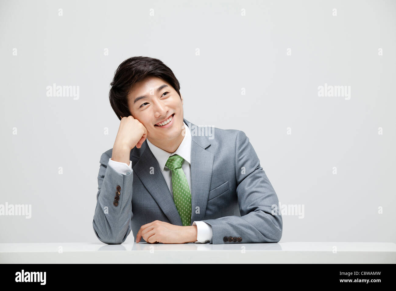 Portrait Of Businessman Resting Head On Hand Stock Photo - Alamy