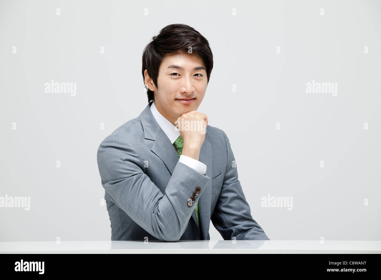 Portrait Of Businessman Resting Head On Hand Stock Photo - Alamy