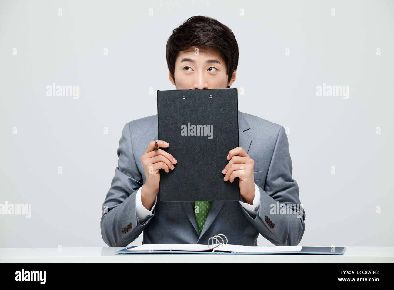 Asian Businessman Holding Pad In Hand At Office Desk Stock Photo - Alamy