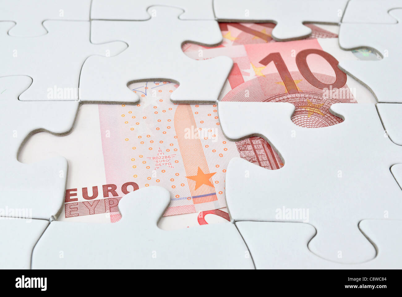 Jigsaw puzzle missing pieces reveal euro banknotes Stock Photo - Alamy