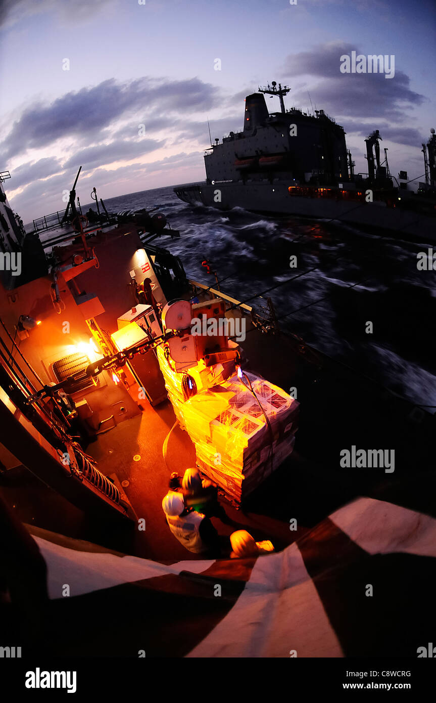 Sailors aboard the guided-missile destroyer USS Mahan (DDG 72) sort ...