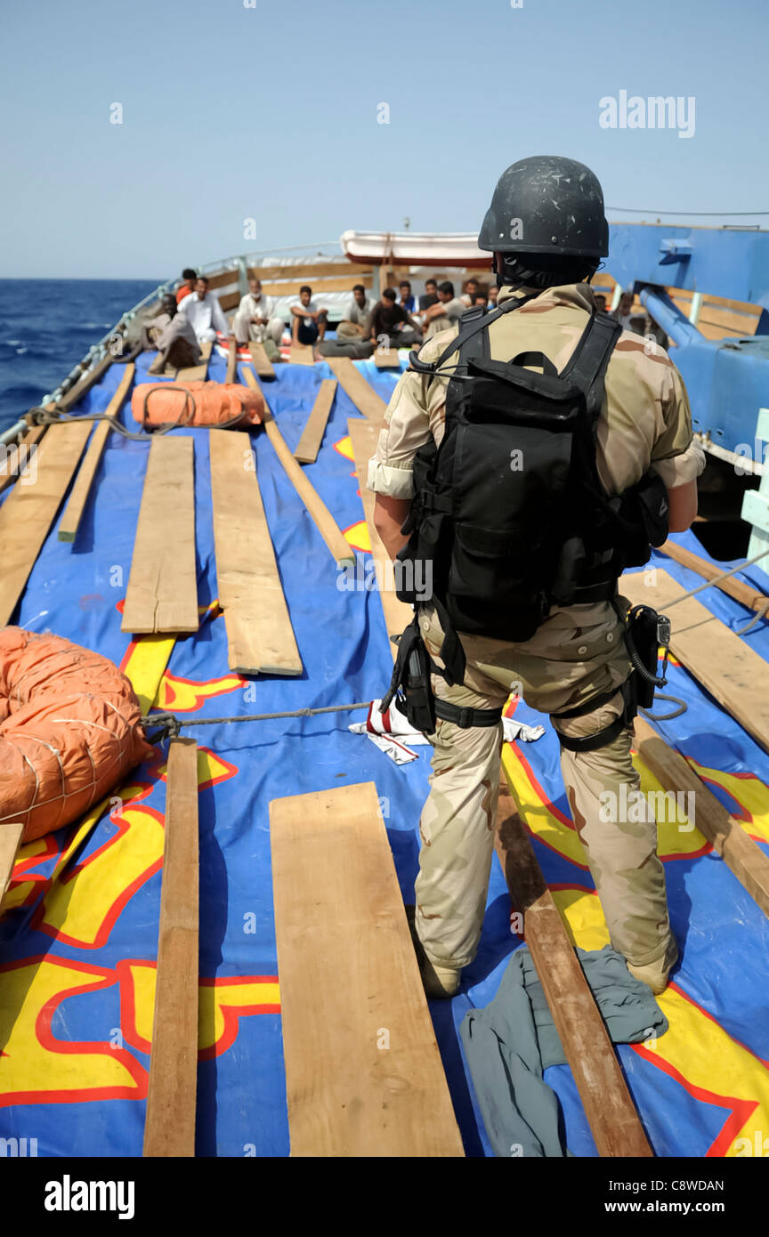 The visit, board, search, and seizure team member guard the crew aboard ...