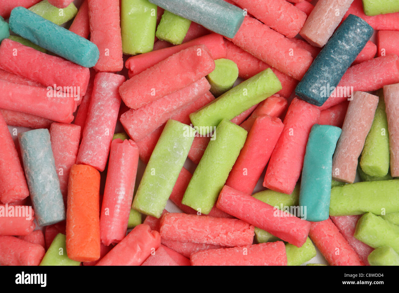 background composed of different colored chewy candies on white Stock ...