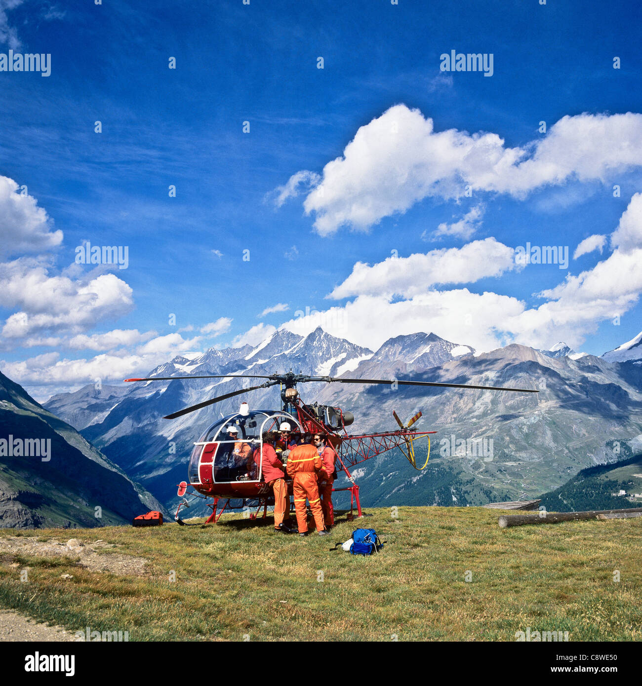 Alouette II rescue helicopter and crew on mountain helipad Zermatt ...