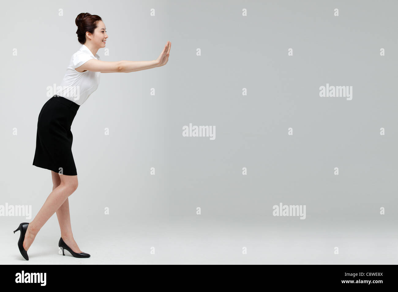 Asian Businesswoman Pushing Stock Photo - Alamy