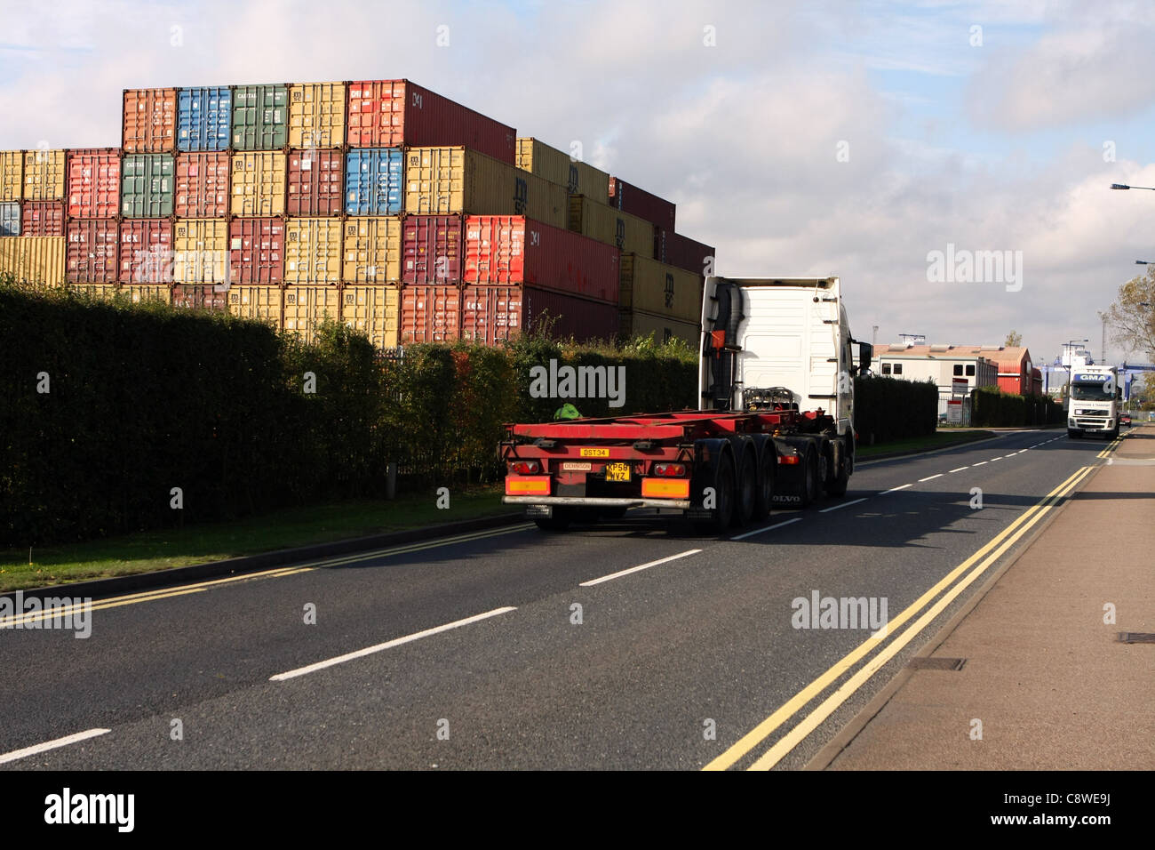 An empty container truck passing a container storage depot in ...
