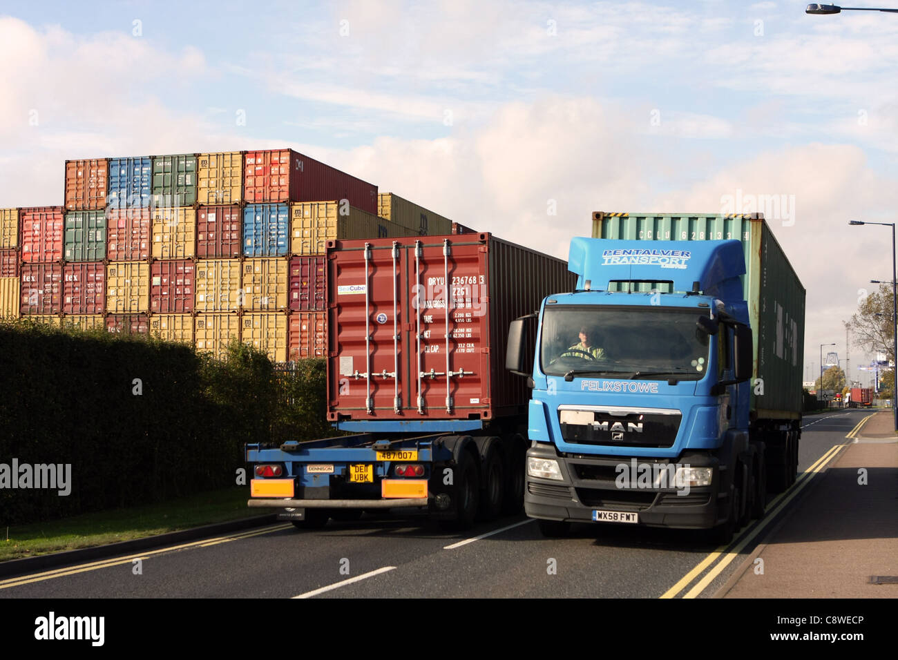 Two container trucks passing a container storage depot in Felixstowe ...