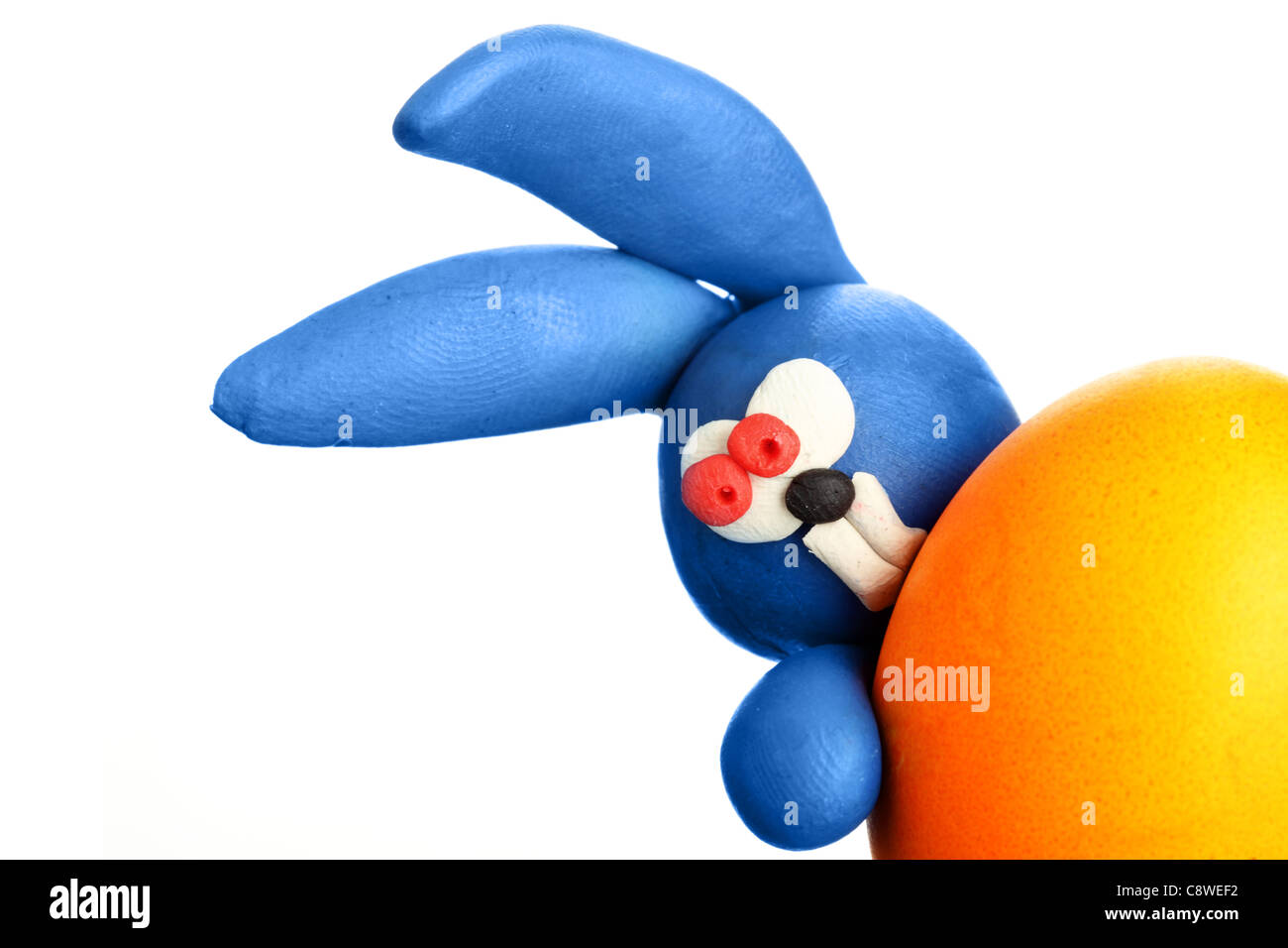 Plasticine rabbit with easter egg isolated over the white background ...