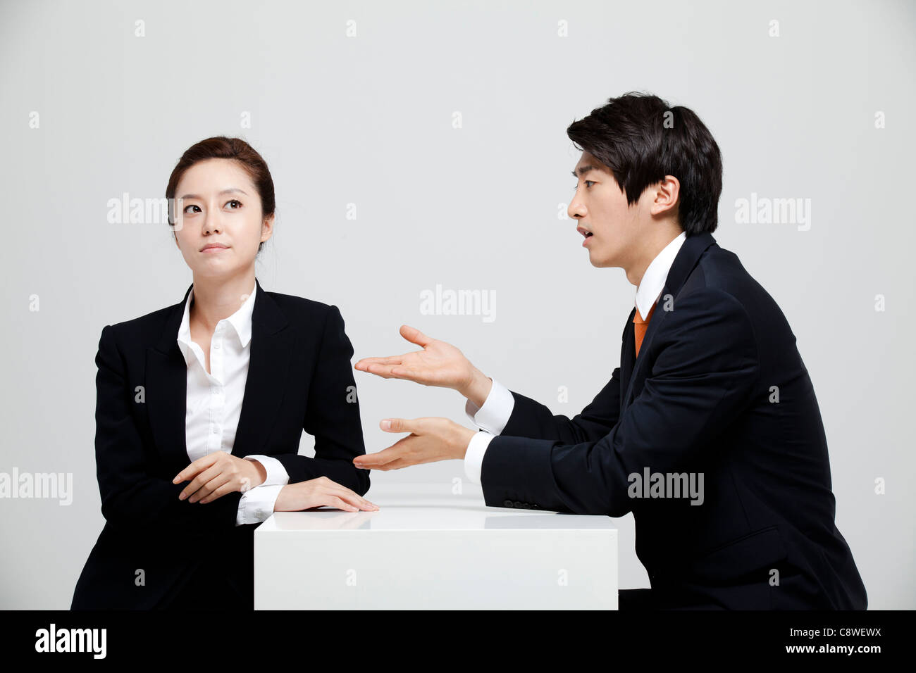 Asian Businesswoman And Businessman Having A Face To Face Discussion ...