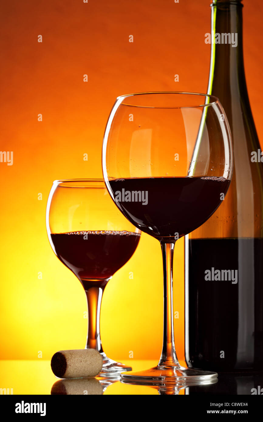 Still-life with glass and bottle of red wine on table Stock Photo - Alamy