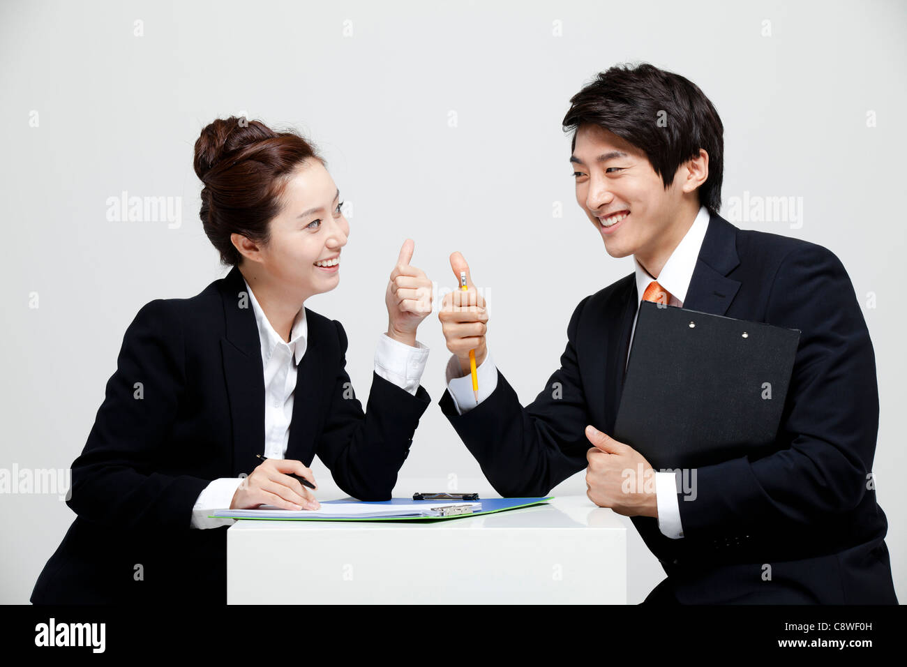 Thumbs up authority sitting face to face hi-res stock photography and ...