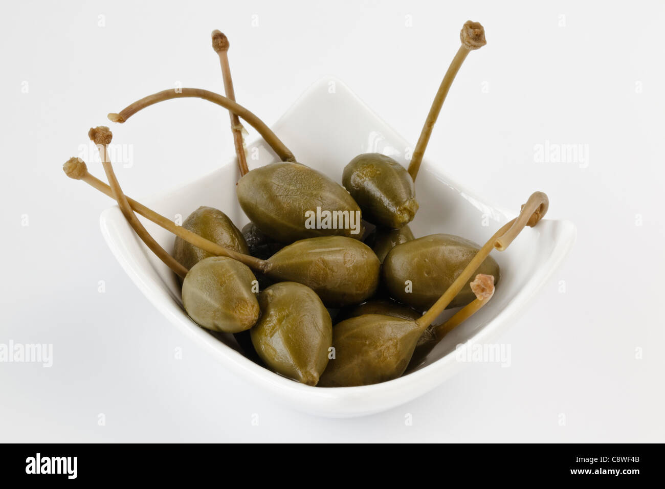 Caperberries in white Bowl Stock Photo - Alamy