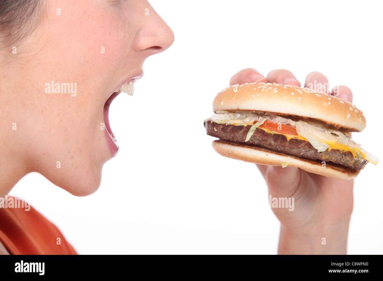 Woman eating cheeseburger Stock Photo - Alamy