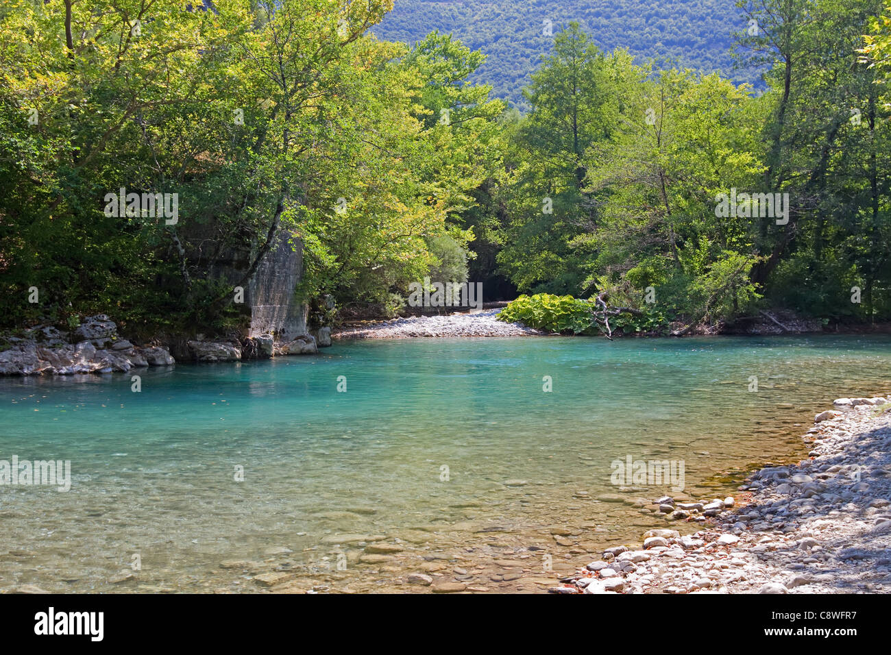The blue waters of Voidomatis river that flows through Epirus region ...