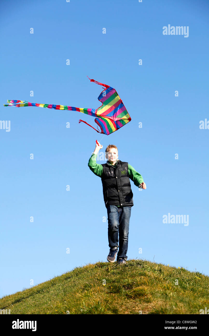 Boy, 13 years old, running with a kite, to let it fly Stock Photo - Alamy