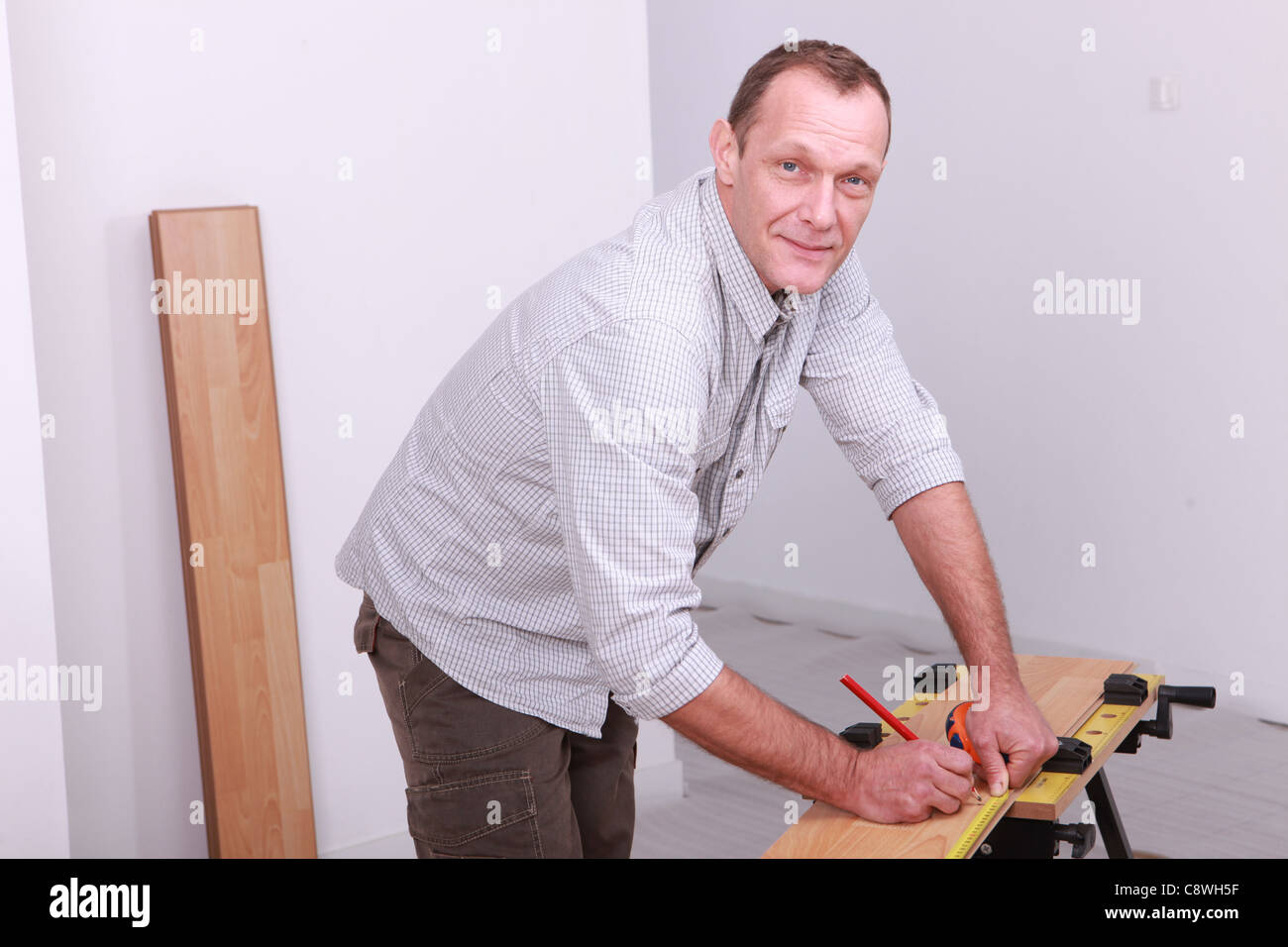 Parquet layer making measures Stock Photo - Alamy