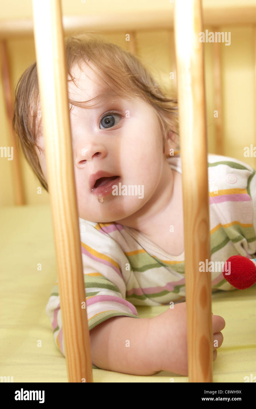 Baby child girl 6-8 months old in crib Stock Photo - Alamy