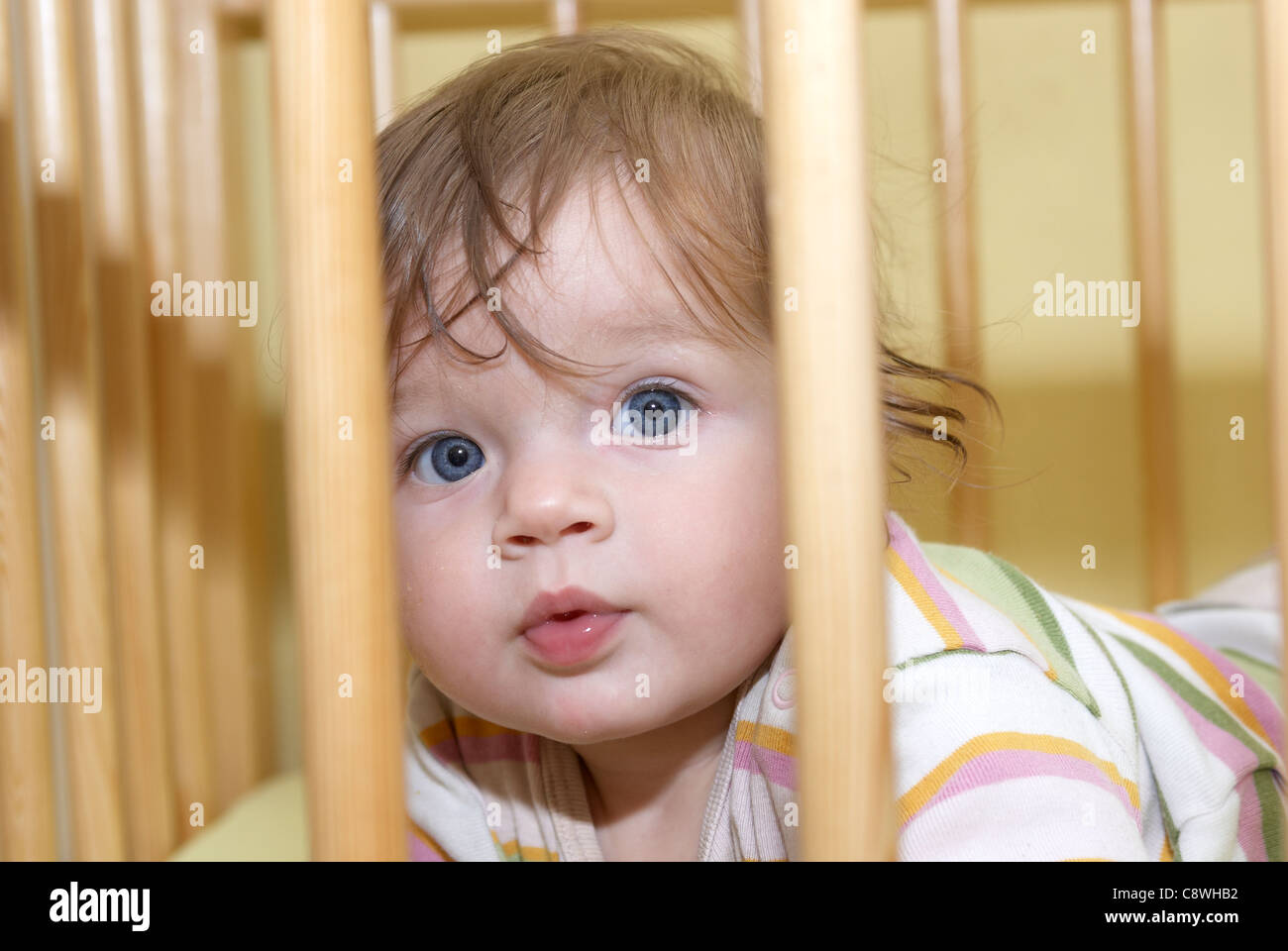 Baby child girl 6-8 months old in crib Stock Photo - Alamy