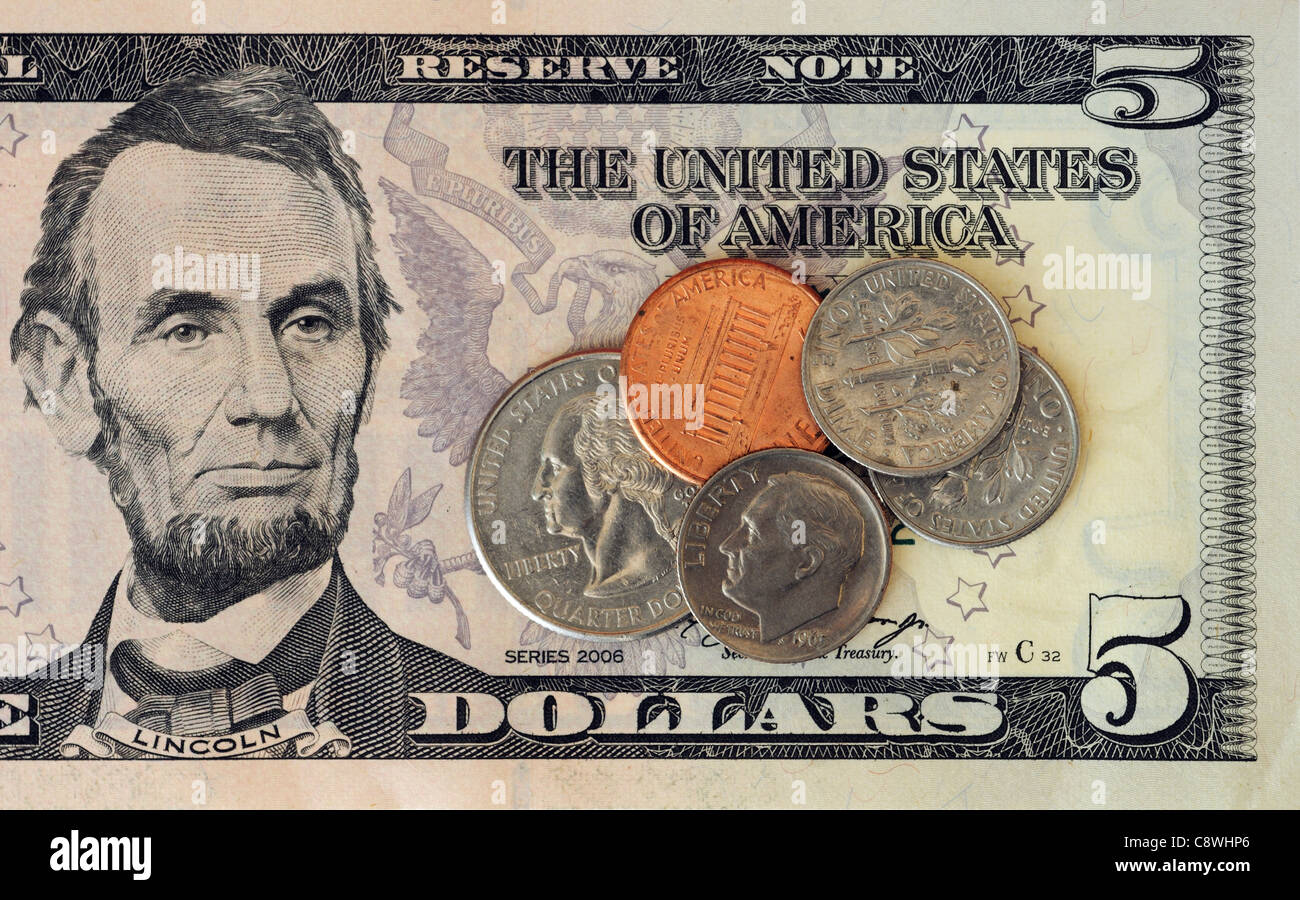 American dollar bill with coins Stock Photo - Alamy