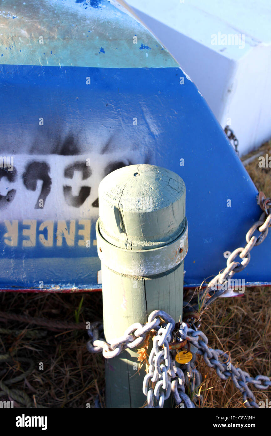 Hull of a blue boat, secured by metal chains and padlocks Stock Photo ...