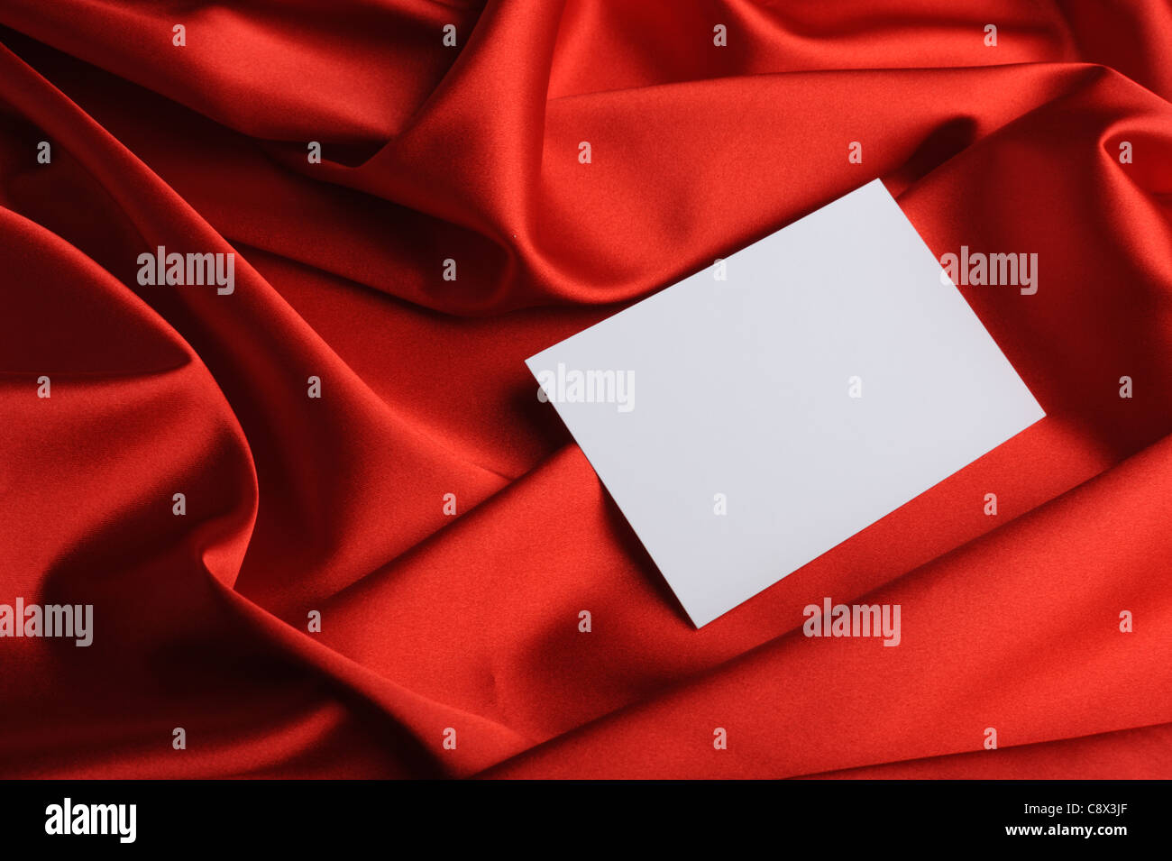 Note on red silk. The empty paper form Stock Photo - Alamy