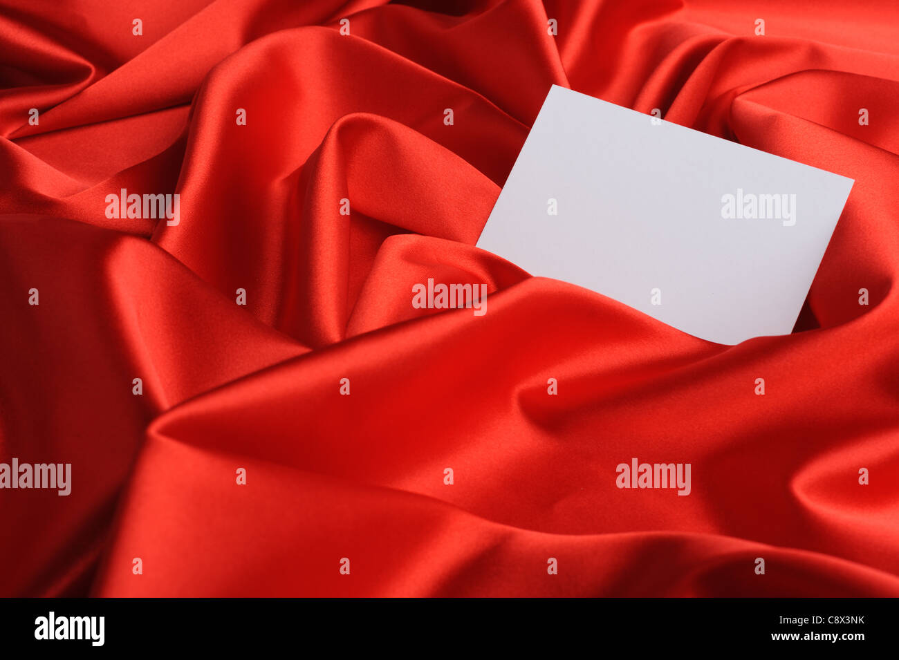 Note on red silk. The empty paper form Stock Photo - Alamy