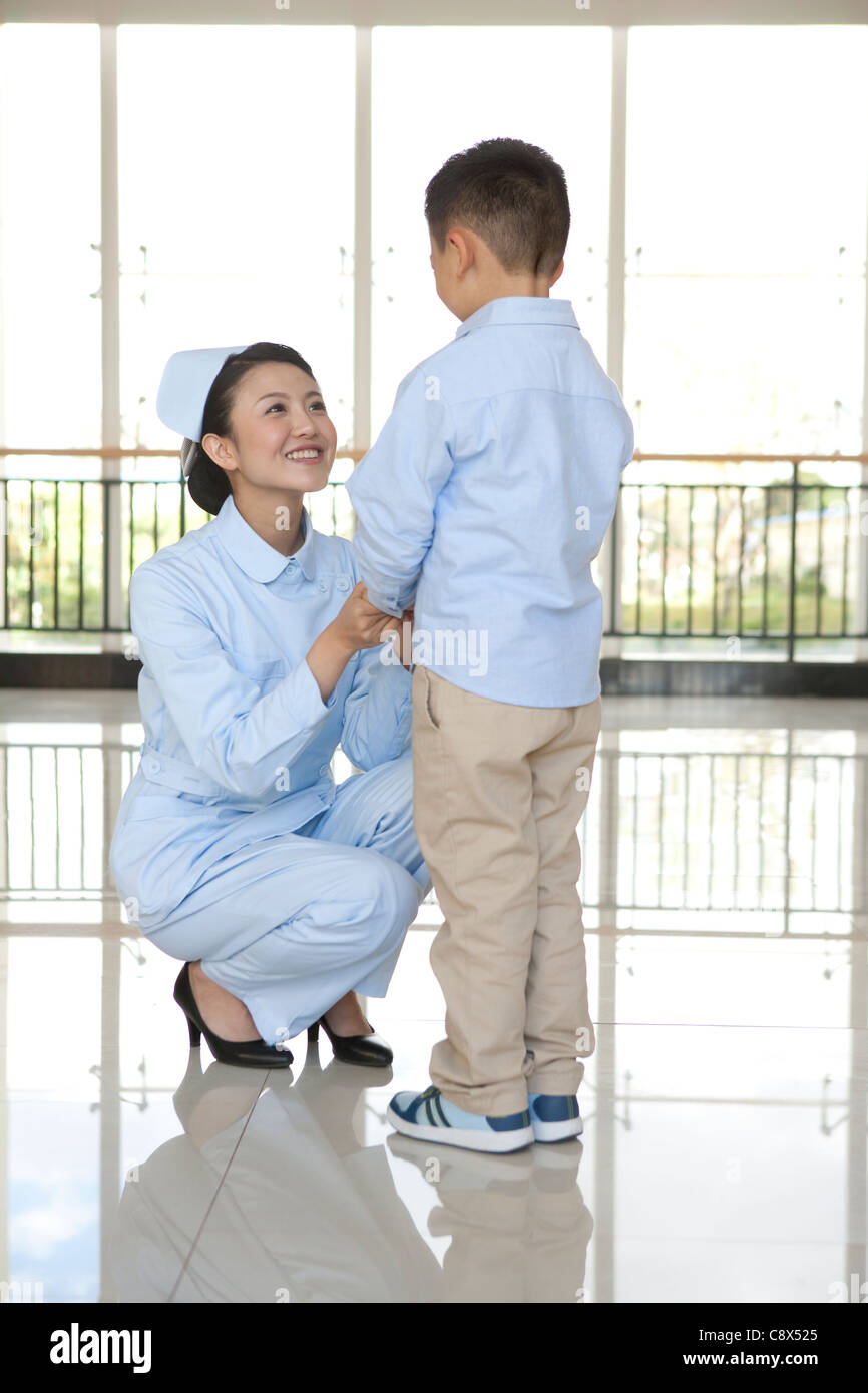 Nurse Talks to Young Boy Stock Photo - Alamy