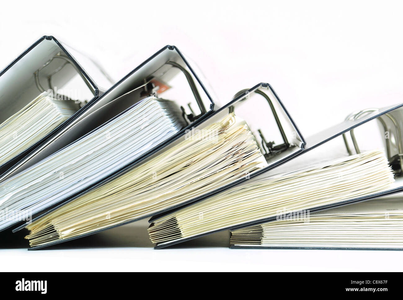 Row of black office files with documents isolated on white background ...