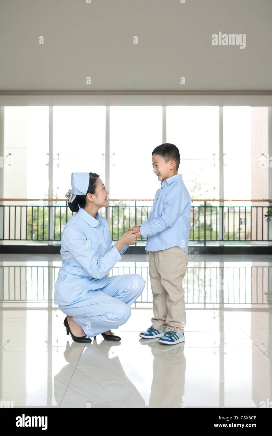 Nurse Talks to Young Boy Stock Photo - Alamy