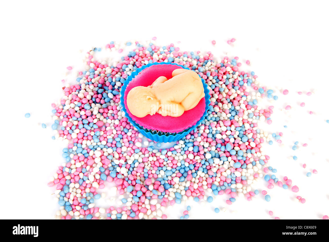 Birth cupcake with marzipan baby and colorful mice sweets over white ...