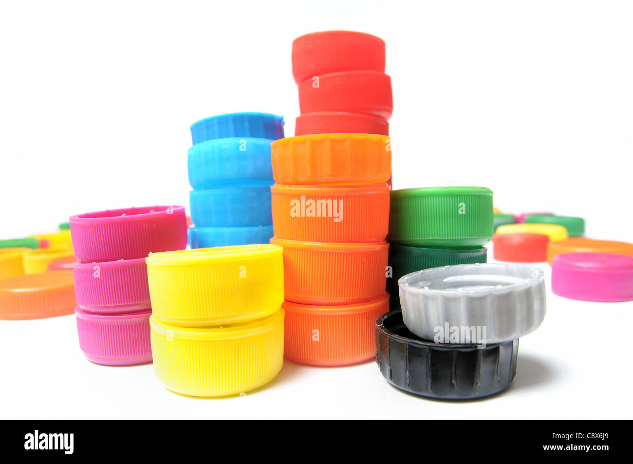 Group of multicolored bottle caps on white background Stock Photo - Alamy