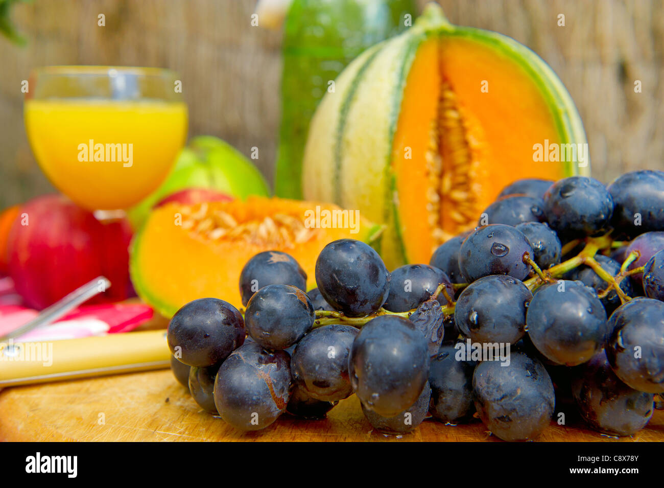 Fresh blue grapes and cut melon Stock Photo - Alamy