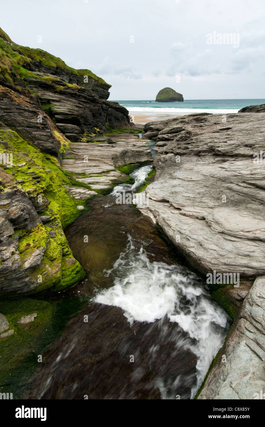 Rushing water in a stream heading out to sea Stock Photo - Alamy