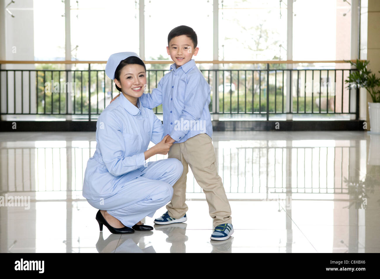 Nurse and Young Boy In a Hospital Corridor Stock Photo - Alamy