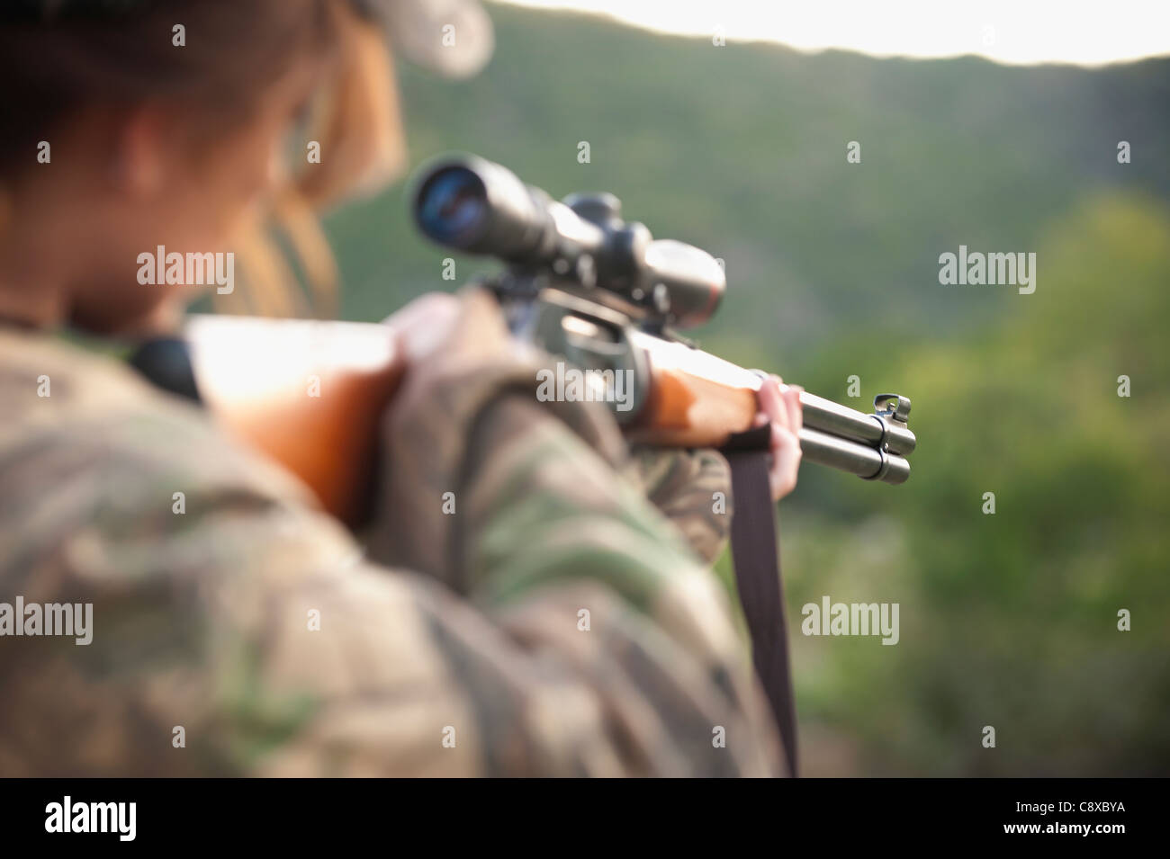 Woman shooting hunting rifle Stock Photo - Alamy