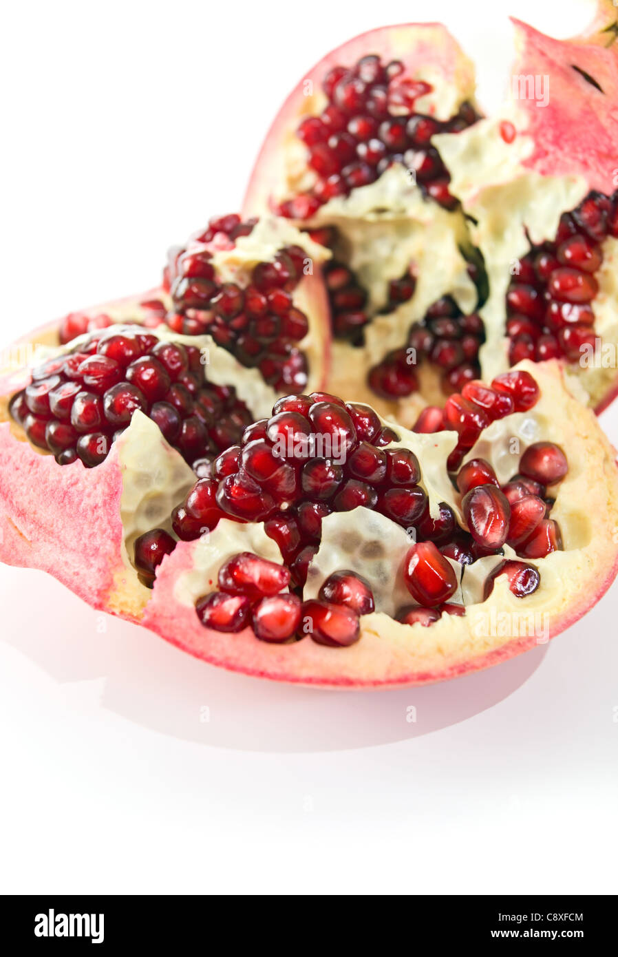 ripe red pomegranate on a white background Stock Photo - Alamy