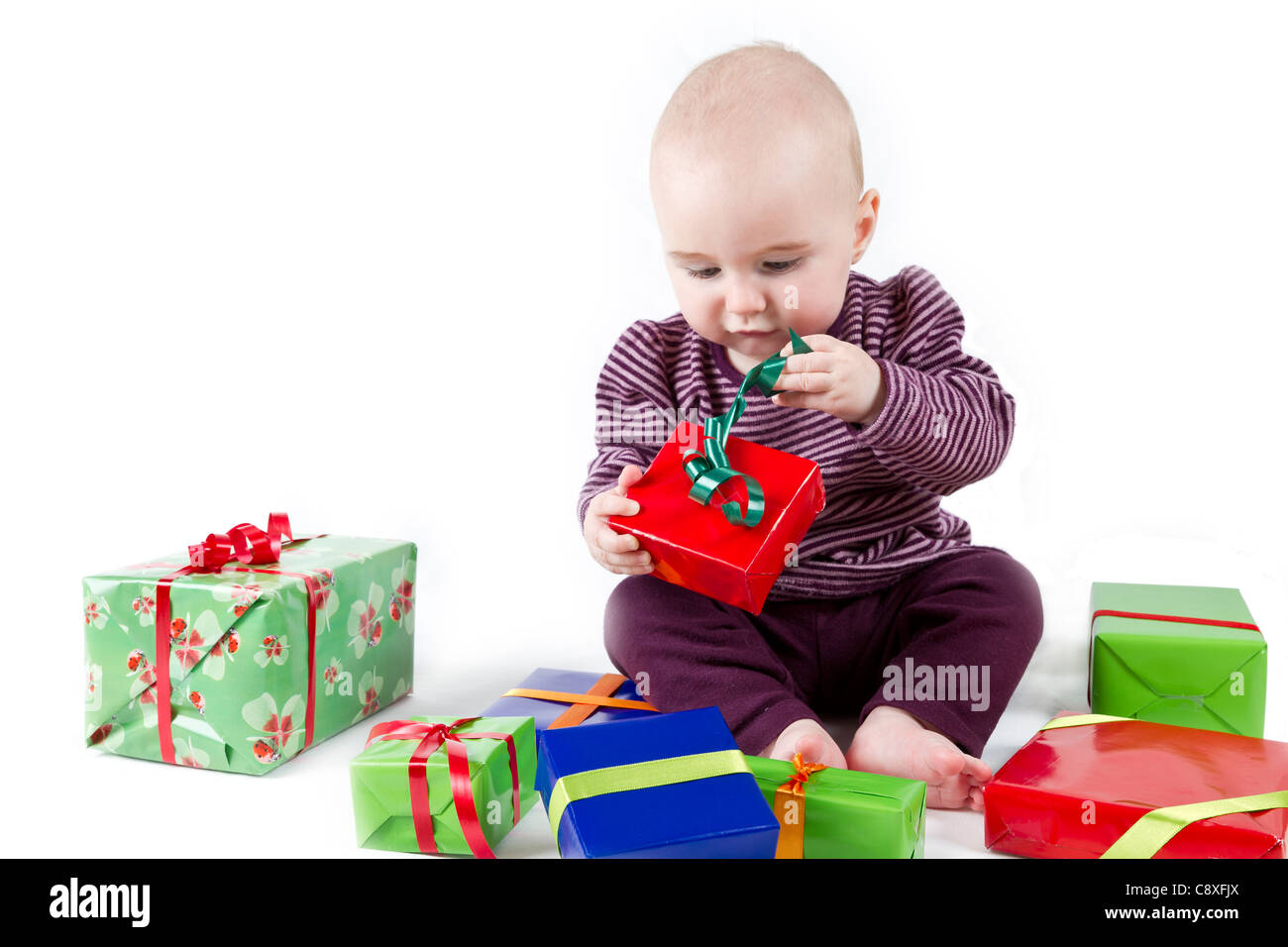 young child unpacking presents. white background Stock Photo - Alamy