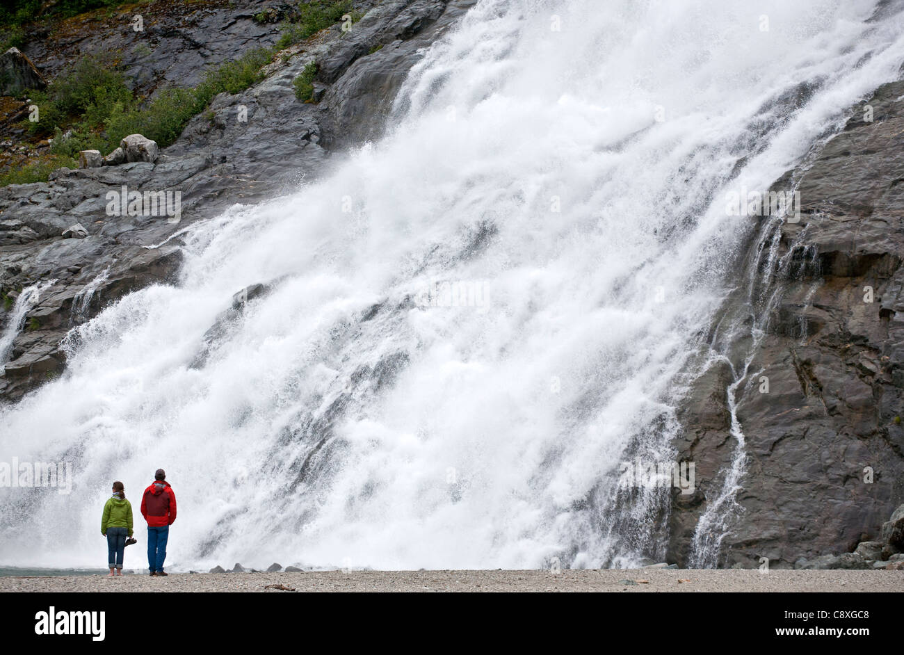 Couple contemplating the Nugget Falls. Mendenhall glacier. Juneau ...