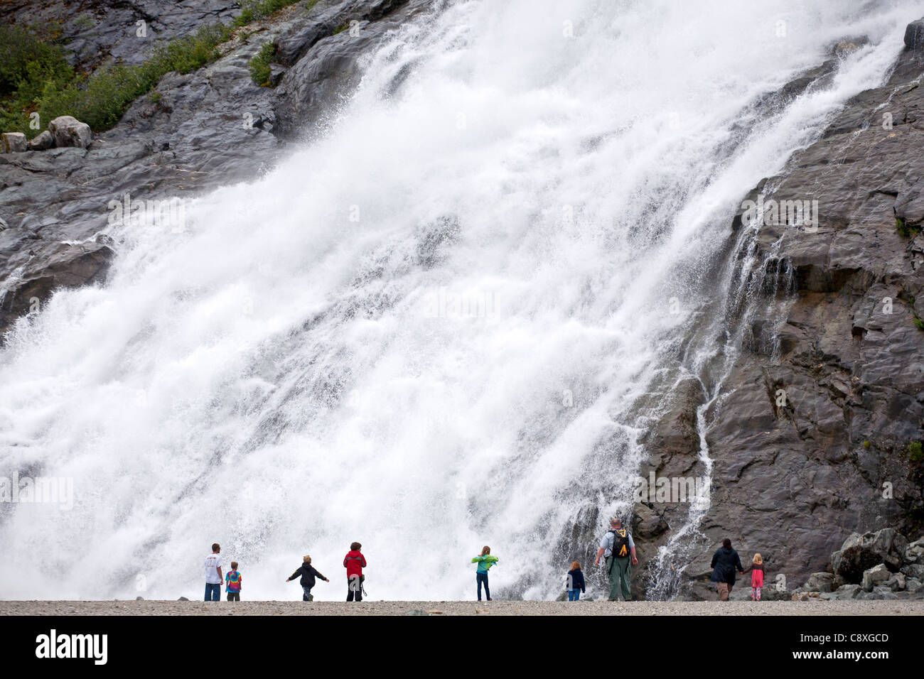 Tourists contemplating the Nugget Falls. Mendenhall glacier. Juneau ...