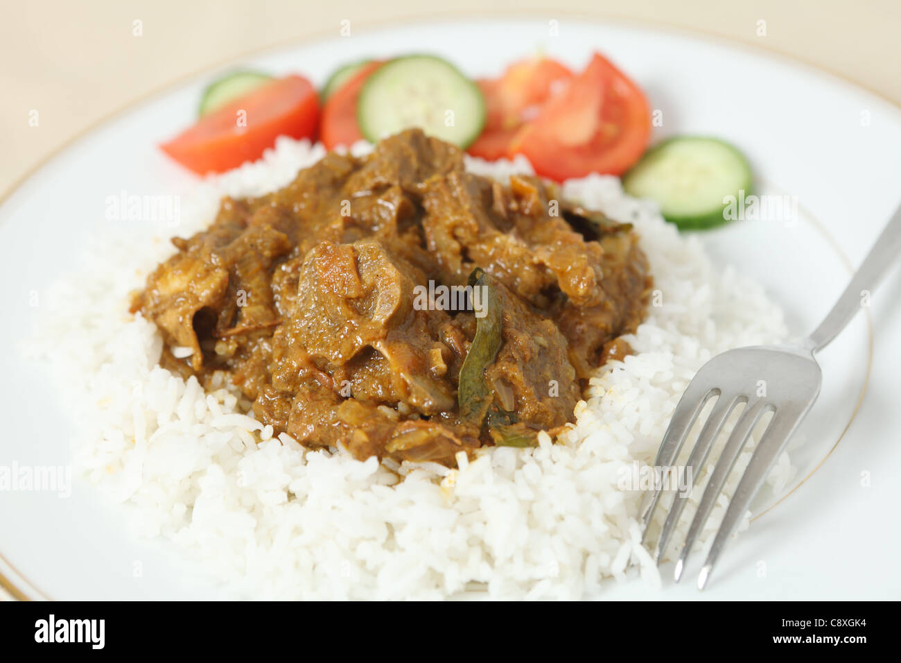 Lamb rogan josh, with basmati rice and a salad of tomato and cucumber ...
