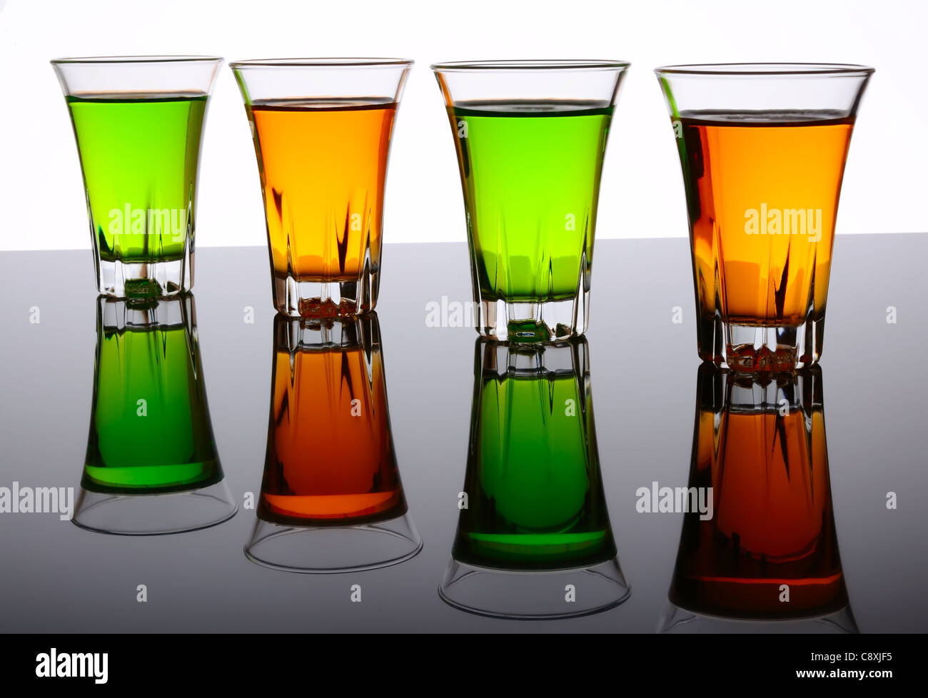 Four small shot glasses of alcoholic beverages Stock Photo - Alamy