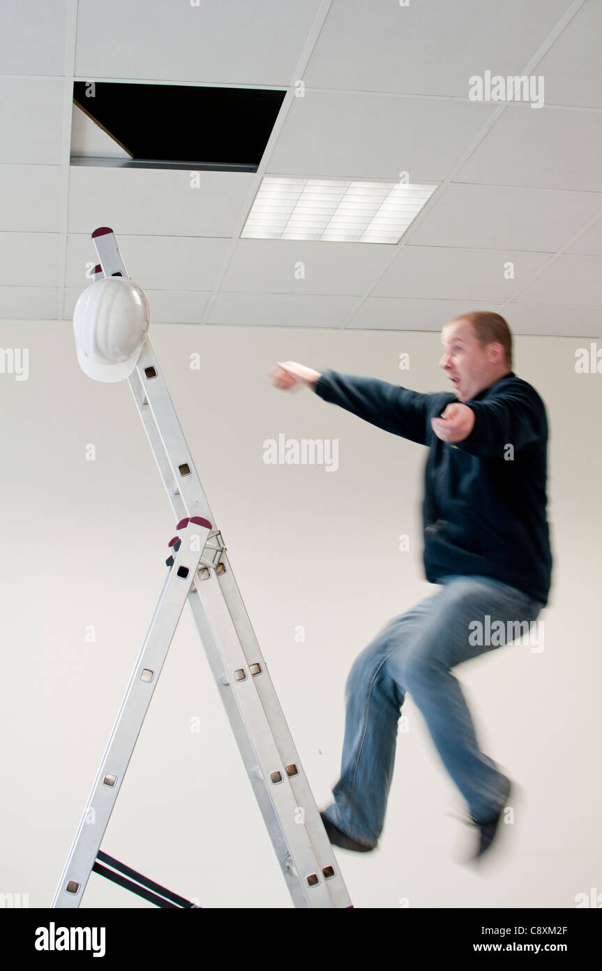 a young man falls from ladder Stock Photo - Alamy