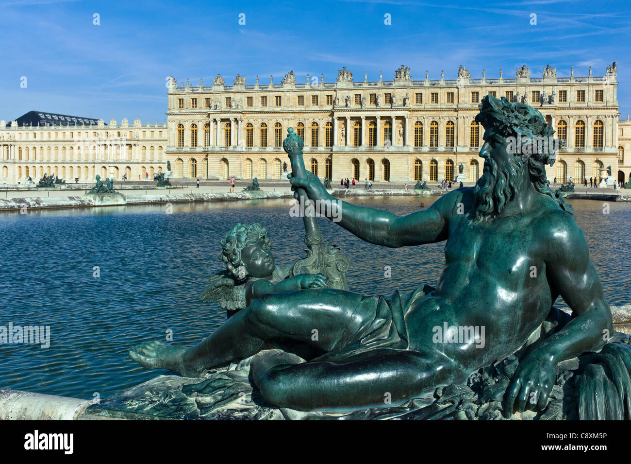 Paris, a statue and the pool of the Royal Palace of Versailles Stock ...